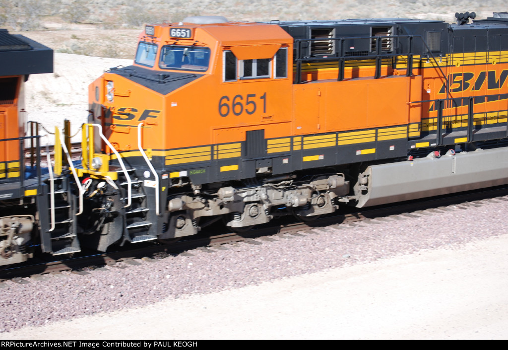 BNSF 6651 slows down `s a #3 unit on a eastbound Z-Train for a crew change at the BNSF Barstow yard.